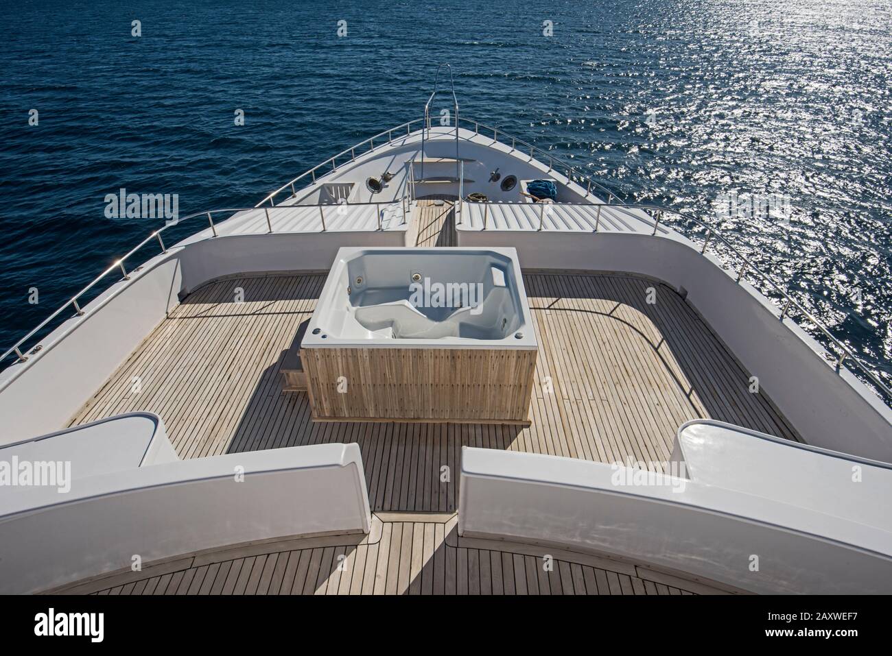 View over the bow of a large luxury motor yacht on tropical open ocean ...
