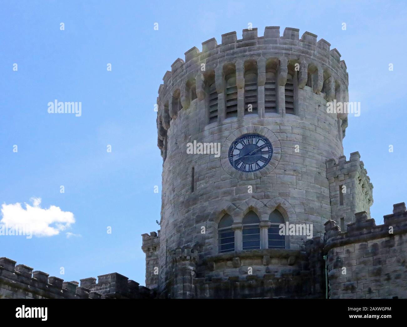 Public clock with Roman numerals outside on old stone tower Stock Photo ...