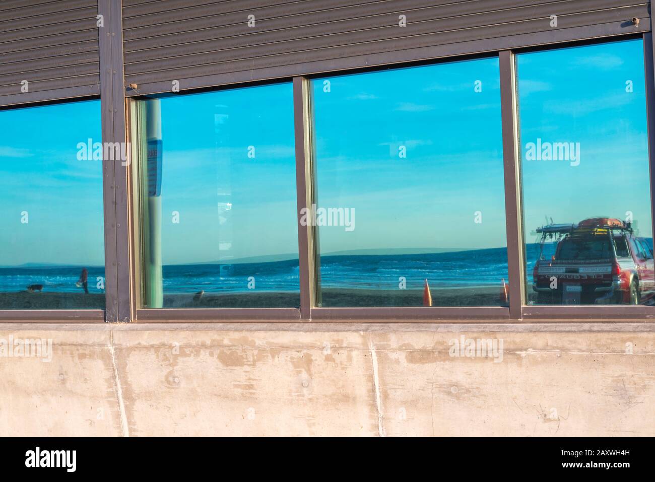 A reflection of the coast in the window of the lifeguard station at La ...