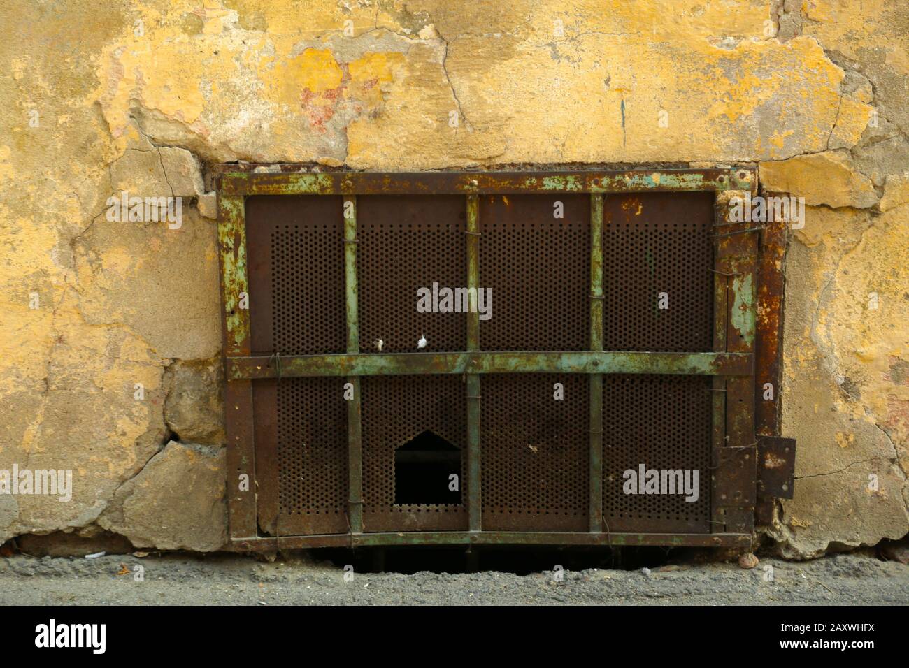 Basement of an old building with falling plaster covered with rusty ...