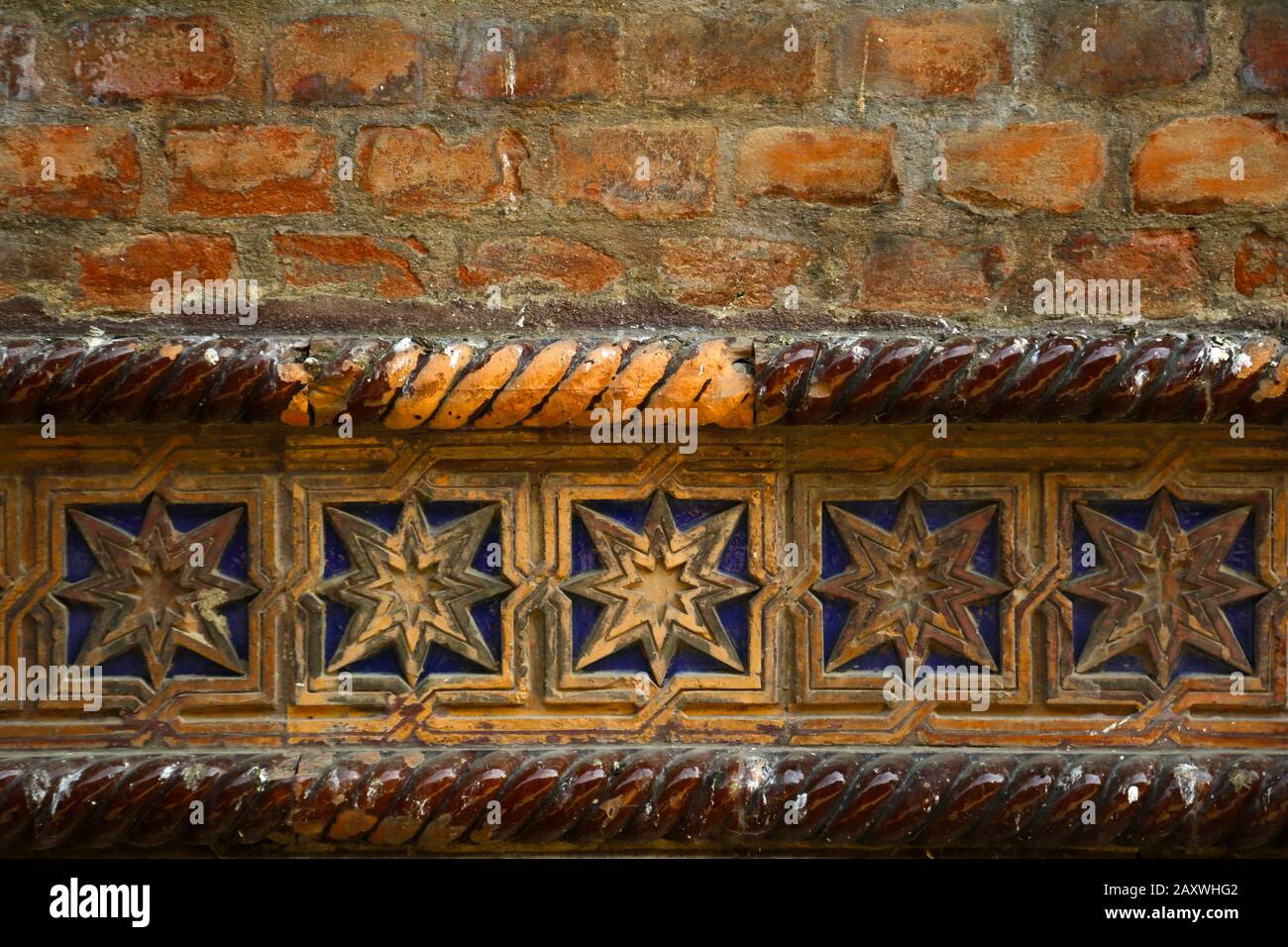 Decorative row of blue glazed tile on a old brick wall of a synagogue ...