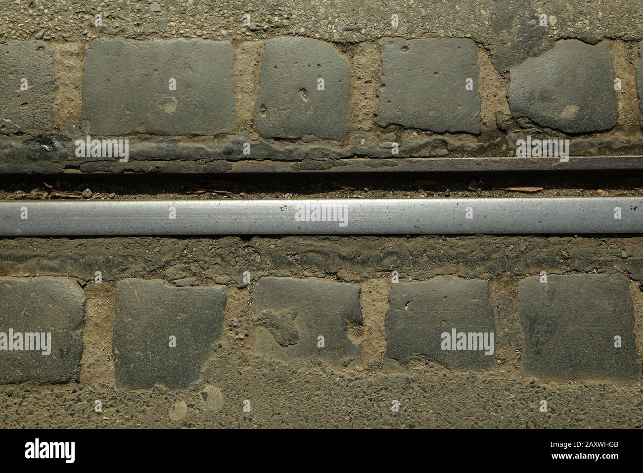 Tramway line and cobblestone tile pavement. Top view. Abstract street ...