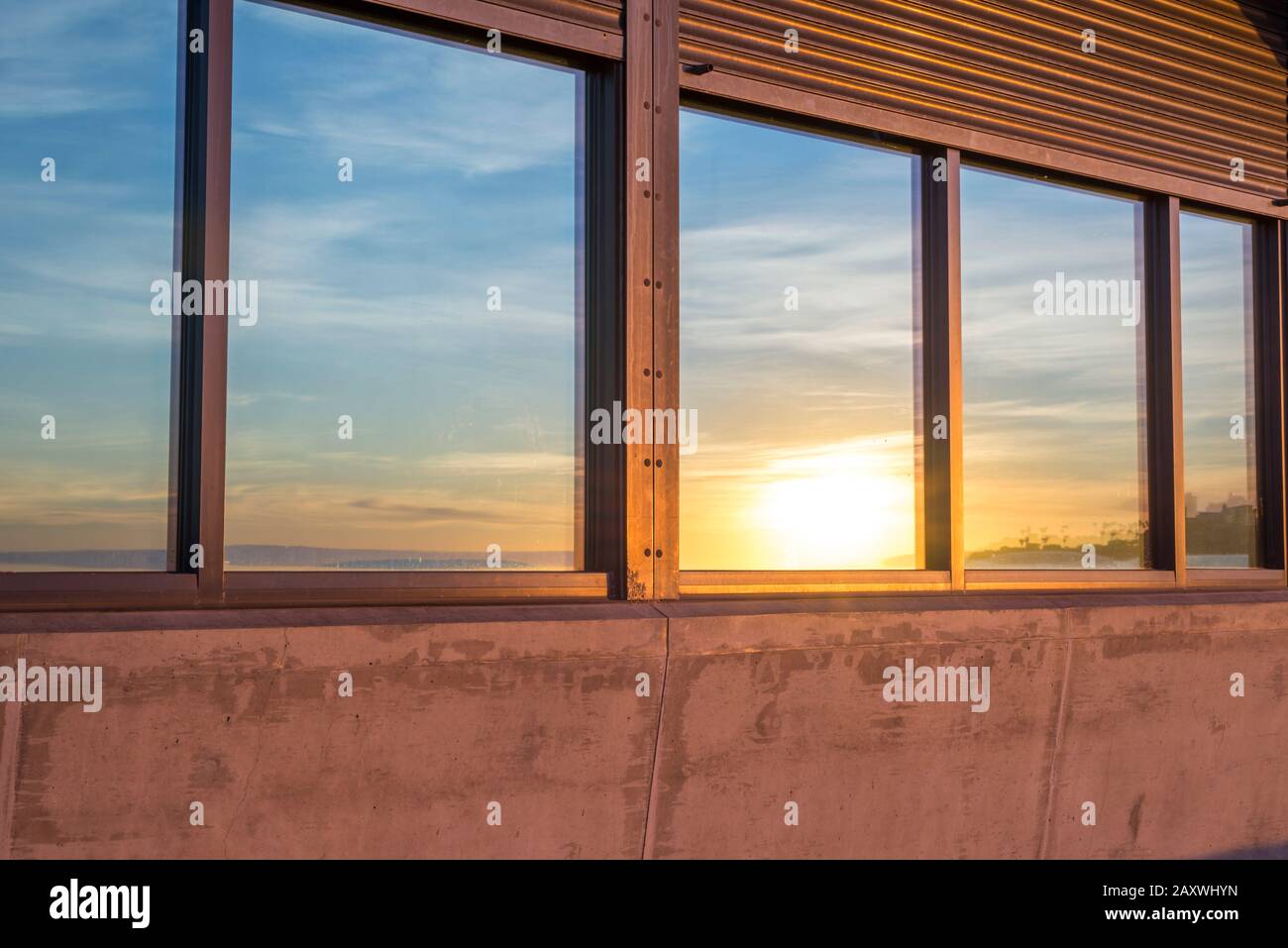 Winter coastal sunset reflection in the window of the lifeguard station ...