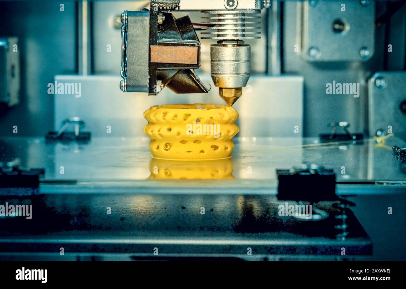 3d printer printing objects yellow form closeup. Modern technical 3D ...