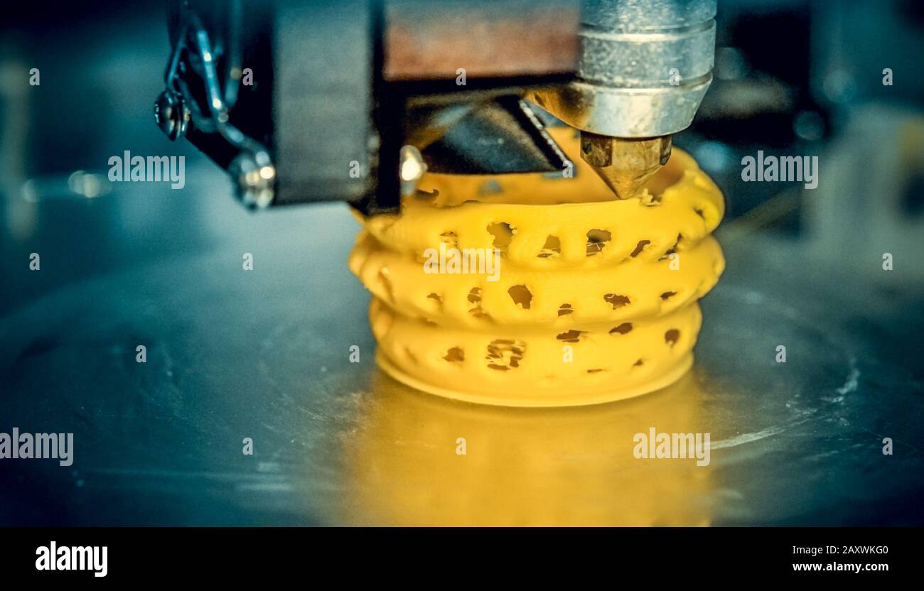 3d printer printing objects yellow form closeup. Modern technical 3D ...