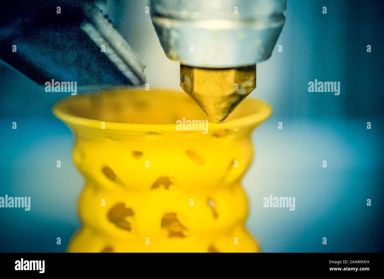 3D printer prints from the plastic figure closeup. 3D printer makes ...