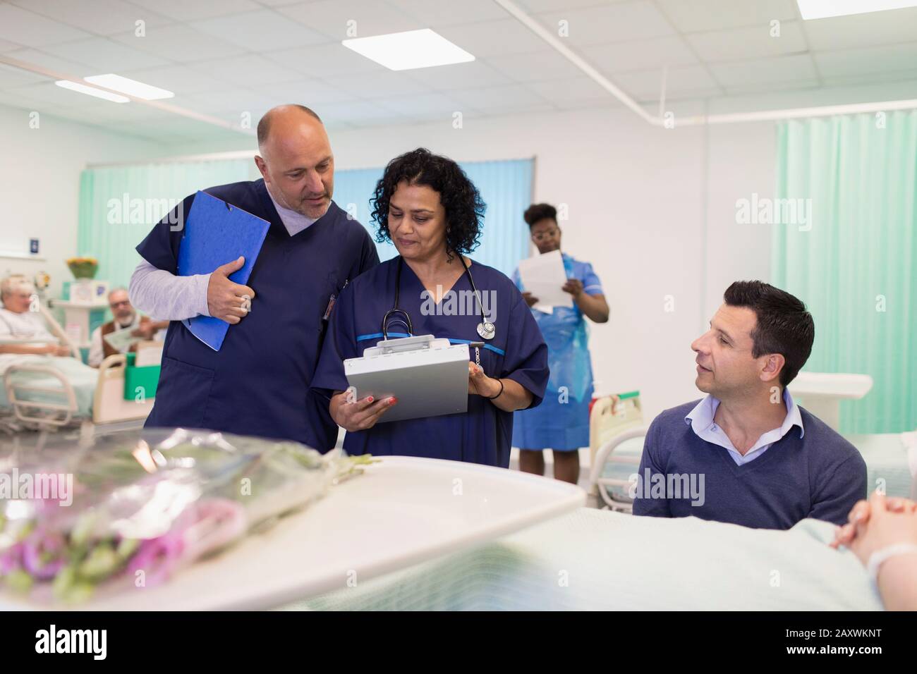 Doctors with medical chart making rounds in hospital ward Stock Photo ...