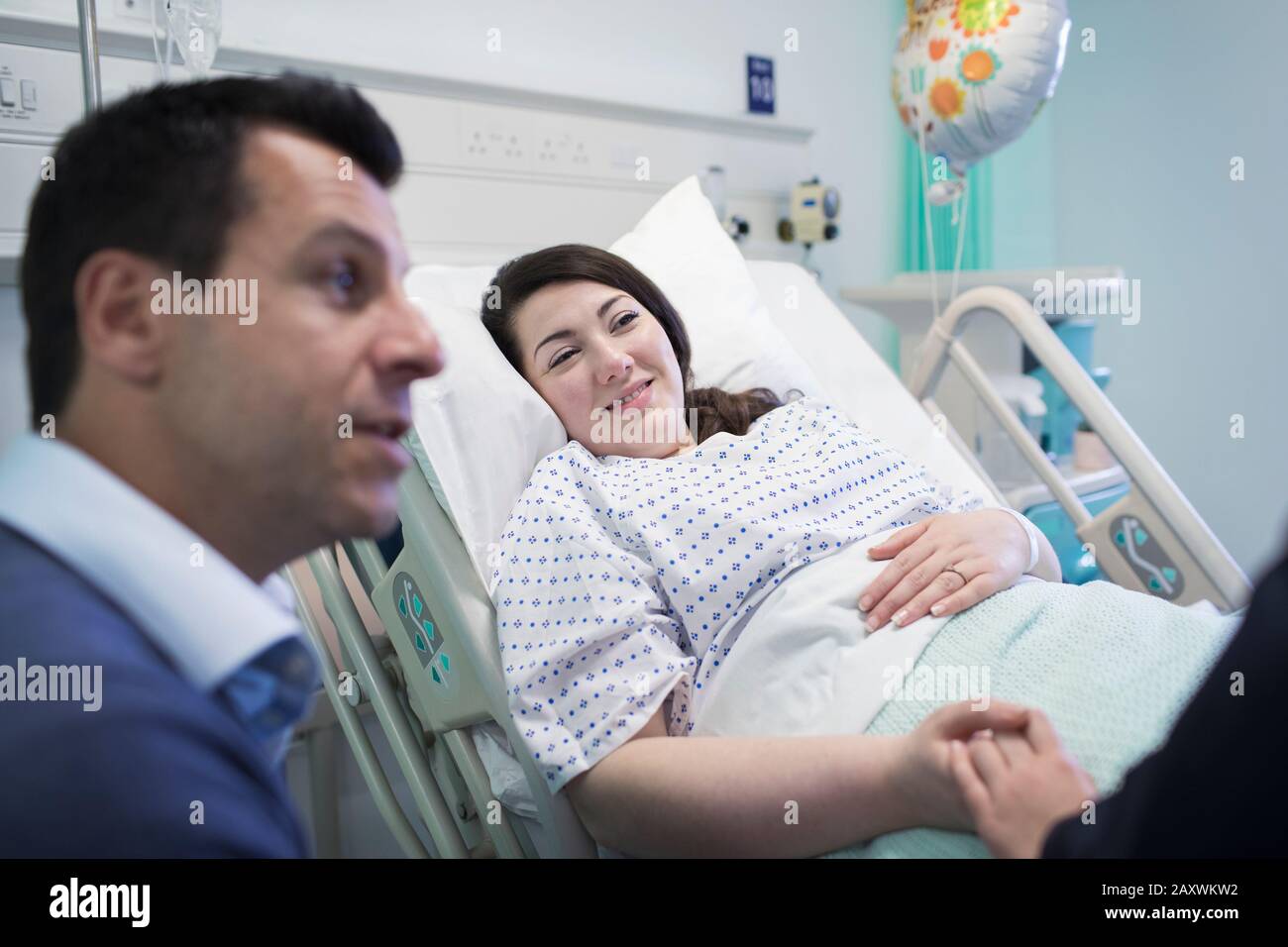 Patient visiting with family in hospital room Stock Photo - Alamy