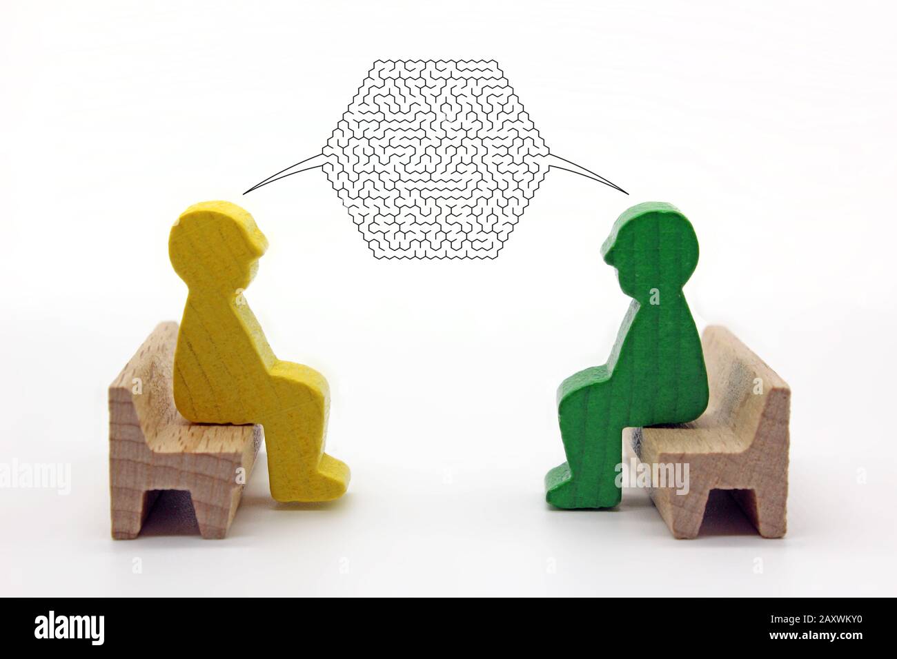 Two men wooden figures sitting on a bench, concept, isolated on a white ...