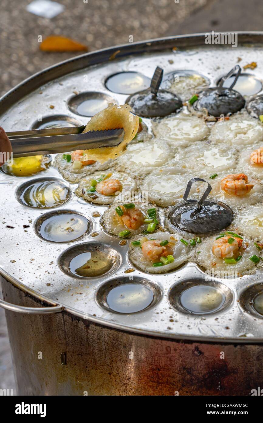 Banh Khot- Vietnamese tiny sizzling shrimp pancake on skillet Stock ...