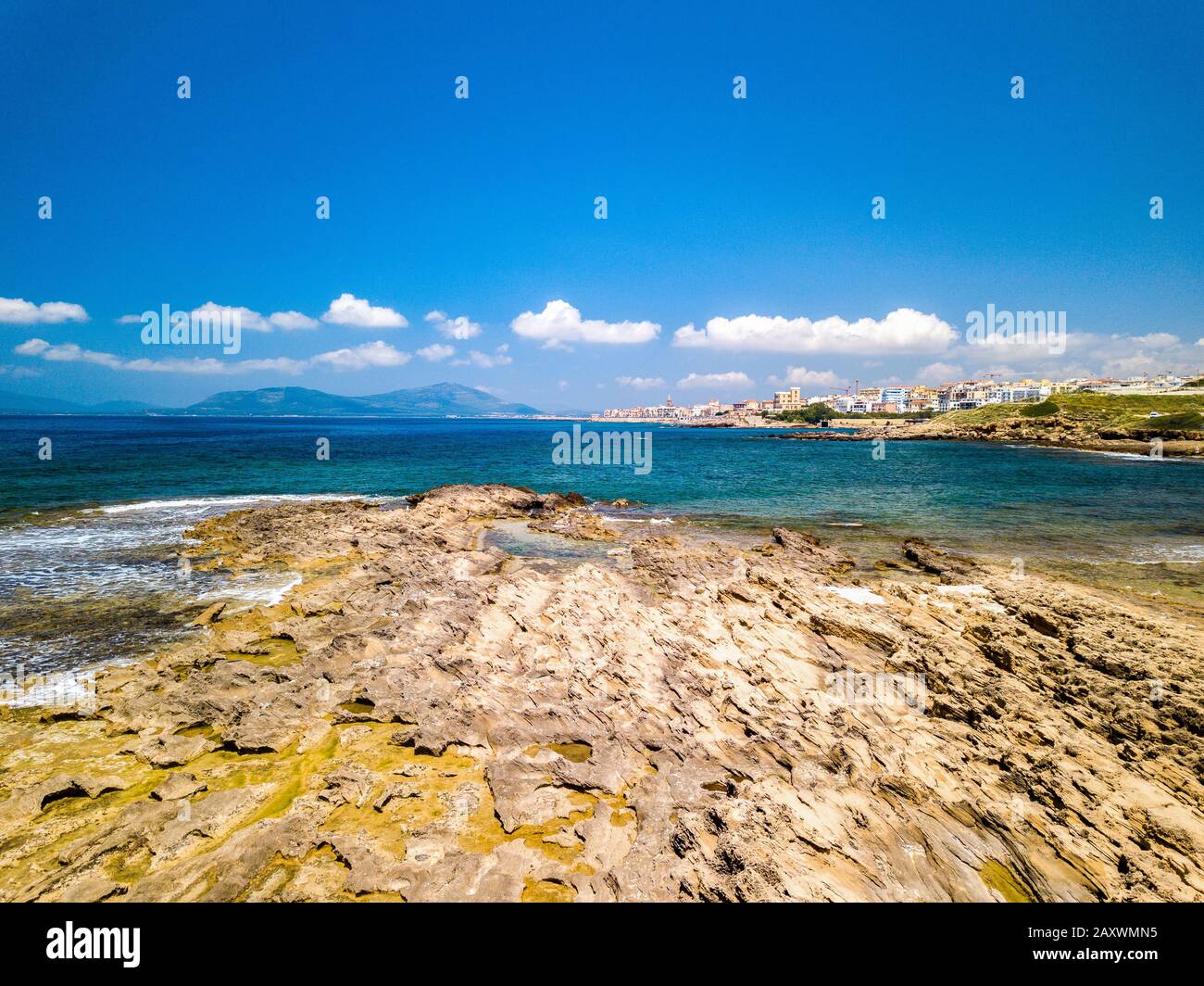 Aerial view of the city of alghero in the distance, sardinia, italy ...