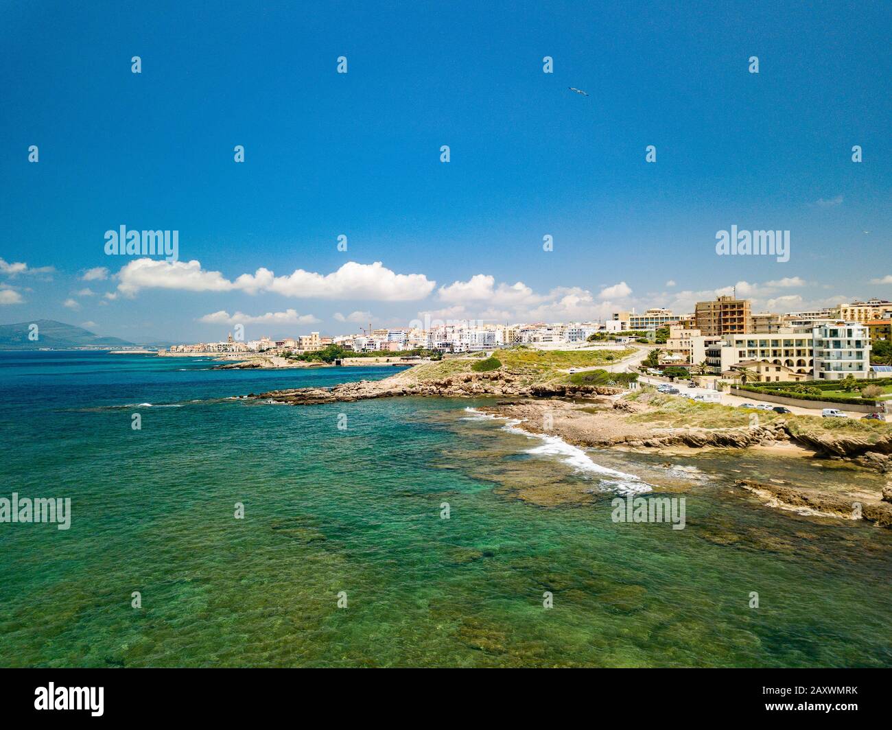 Aerial view of the city of alghero in the distance, sardinia, italy ...