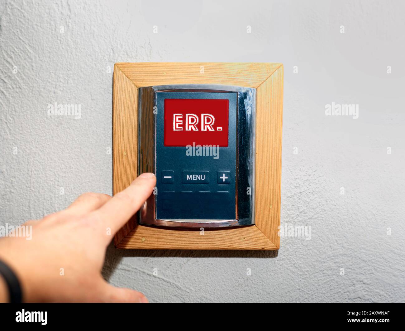 A hand next to abstract device with error message on display Stock ...