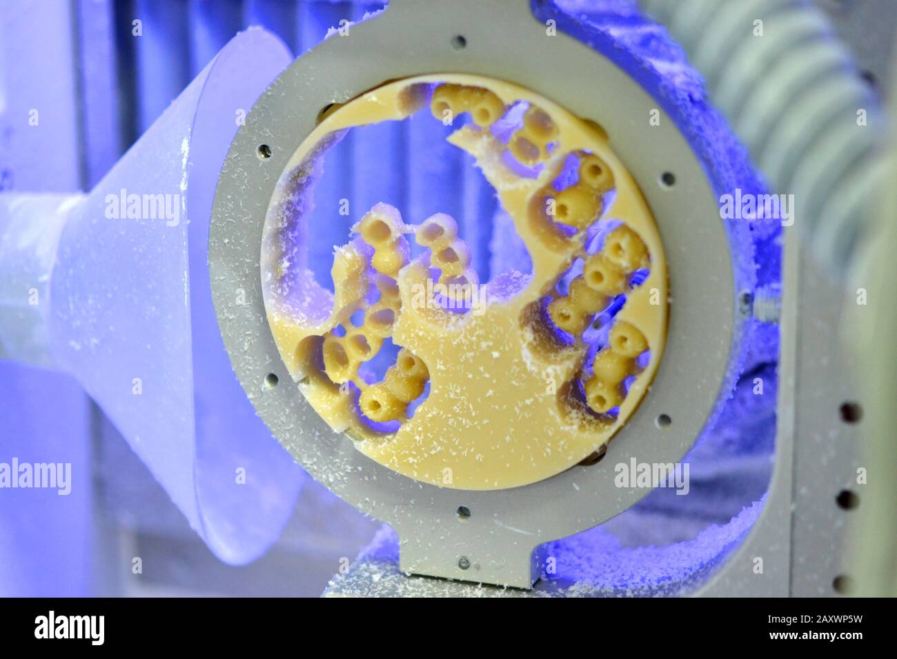 Dental milling machine carving out shape of human teeth close-up ...