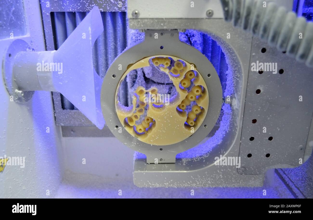 Dental milling machine carving out shape of human teeth close-up ...