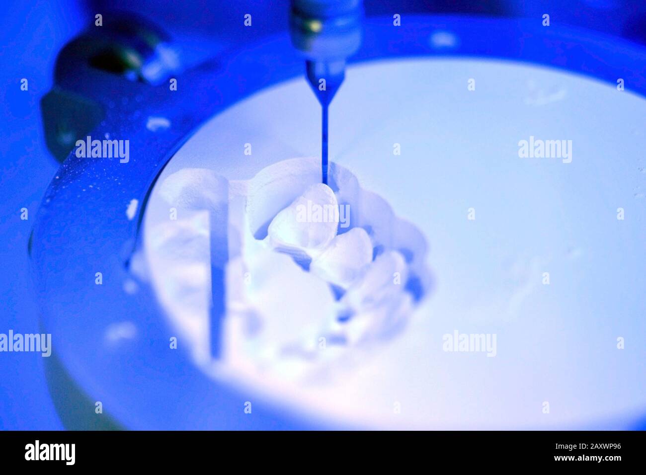 Dental milling machine carving out shape of human teeth close-up ...