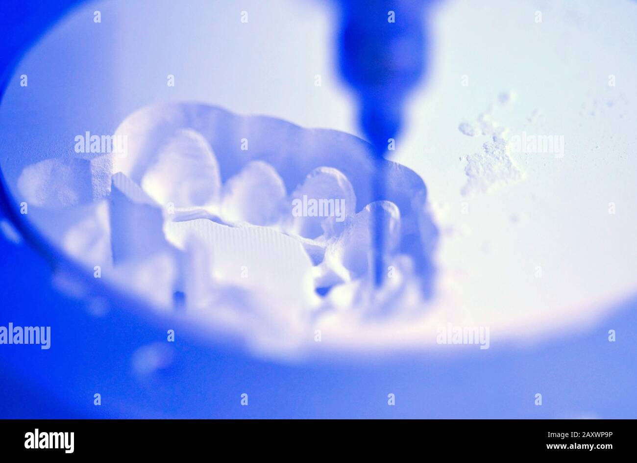 Dental milling machine carving out shape of human teeth close-up ...