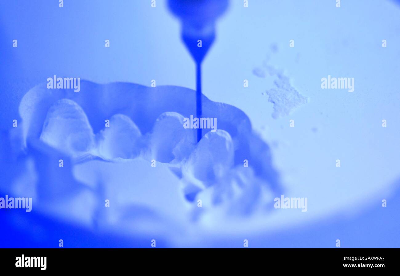 Dental milling machine carving out shape of human teeth close-up ...