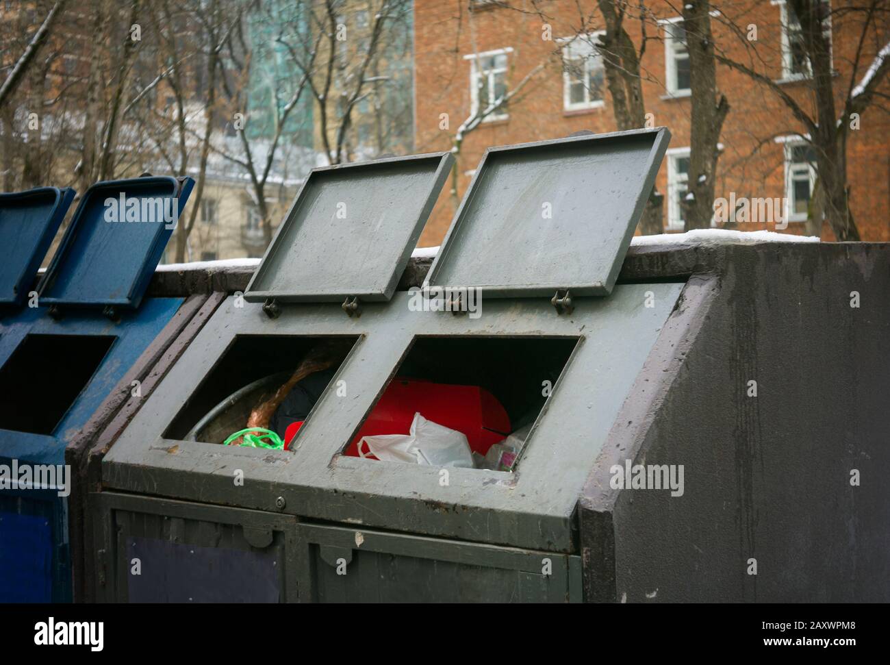 Row of full garbage containers, outdoor urban scene Stock Photo - Alamy