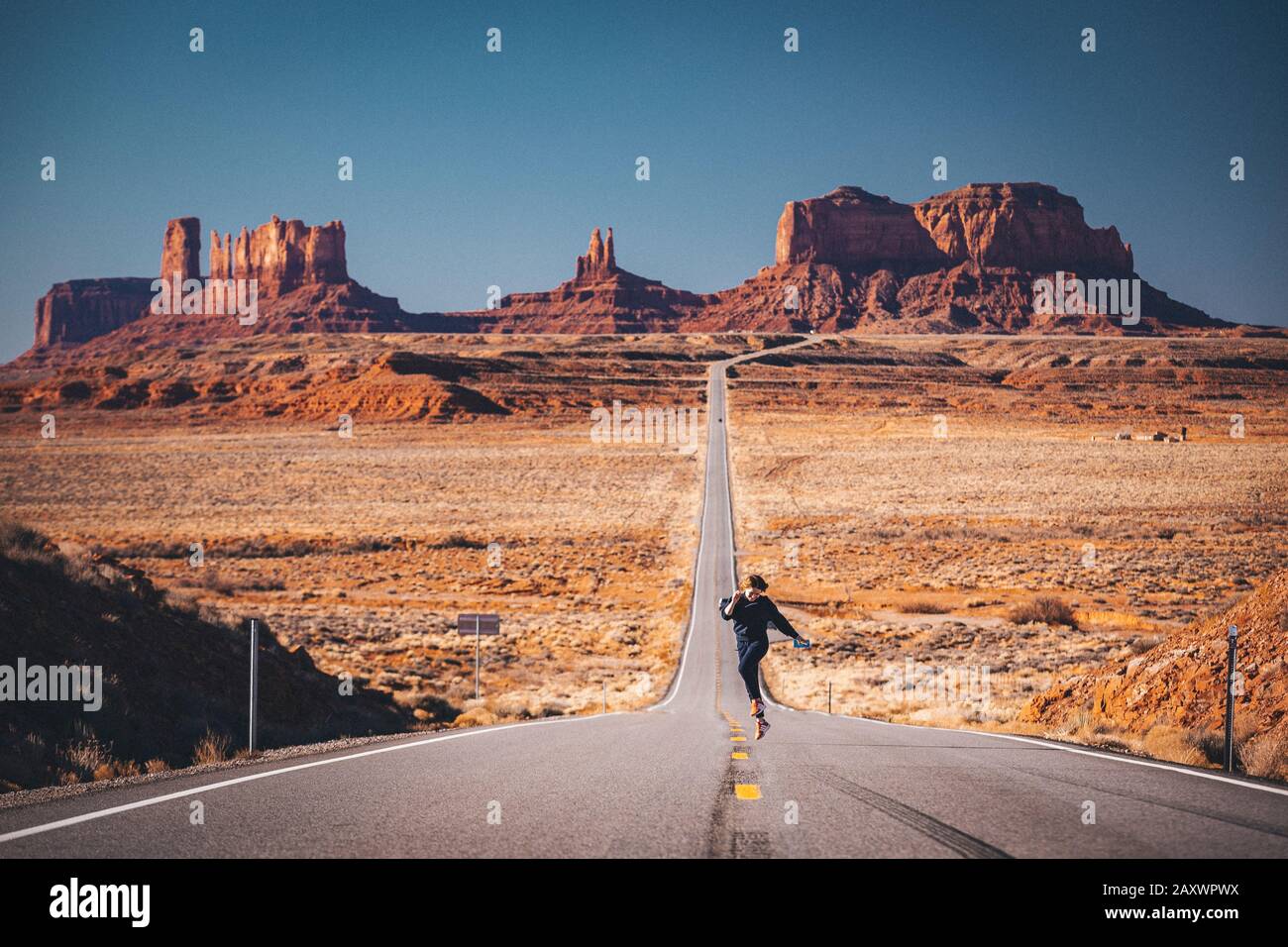 Girl is jumping on the road near Forrest Gump Point, Monument Valley ...
