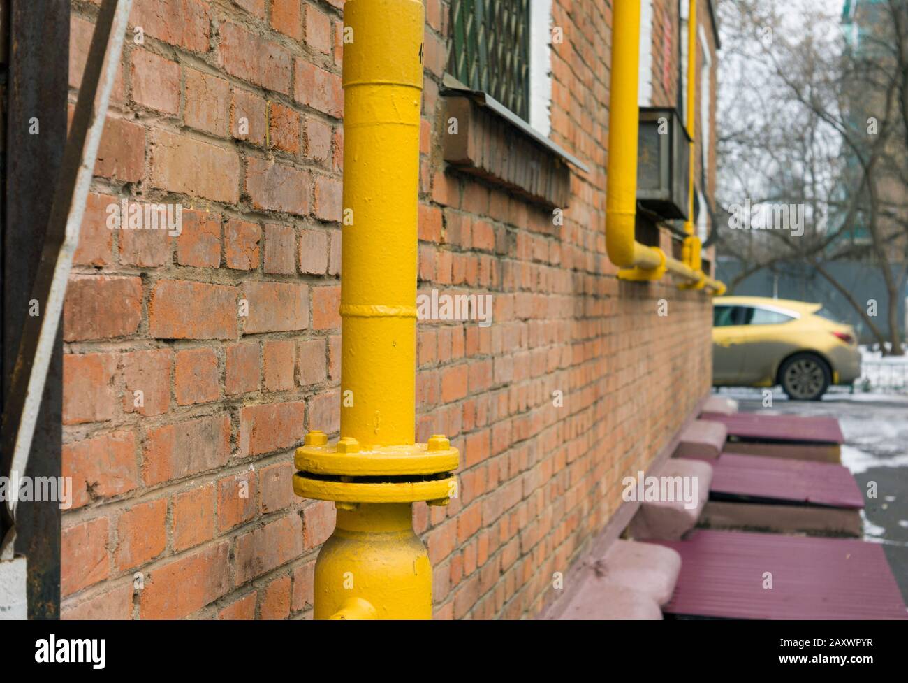 Gas pipe line mounted on the building, urban scene Stock Photo - Alamy