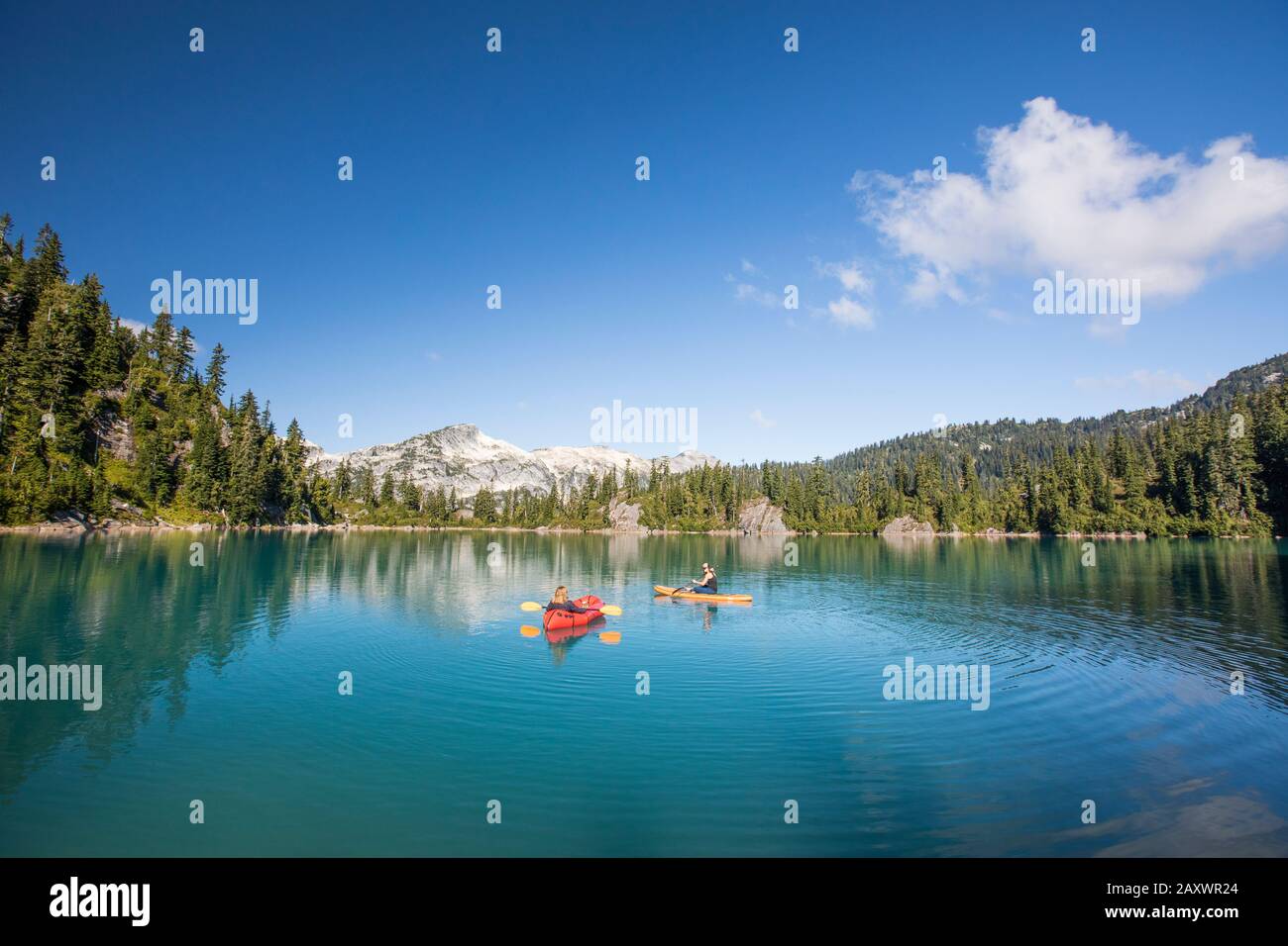 Mother and daughter float on beautiful blue alpine lake Stock Photo - Alamy