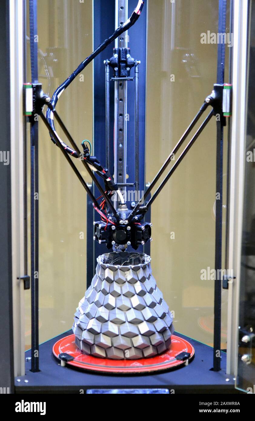 3d printer and object printed on it close-up. Progressive modern ...
