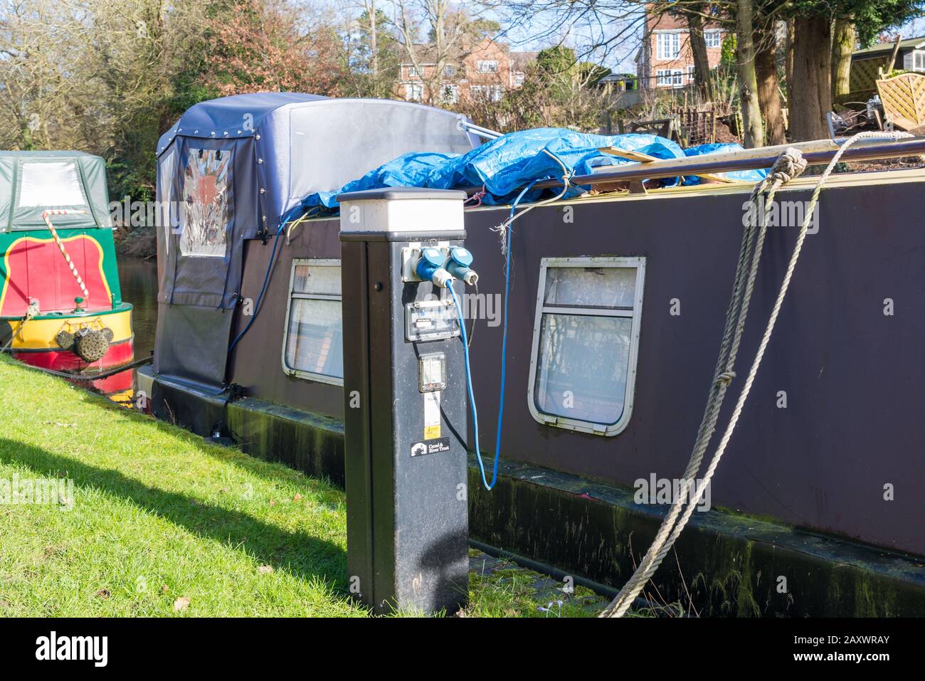 Narrowboat plugged into electricity socket on the River Stour at Kinver ...