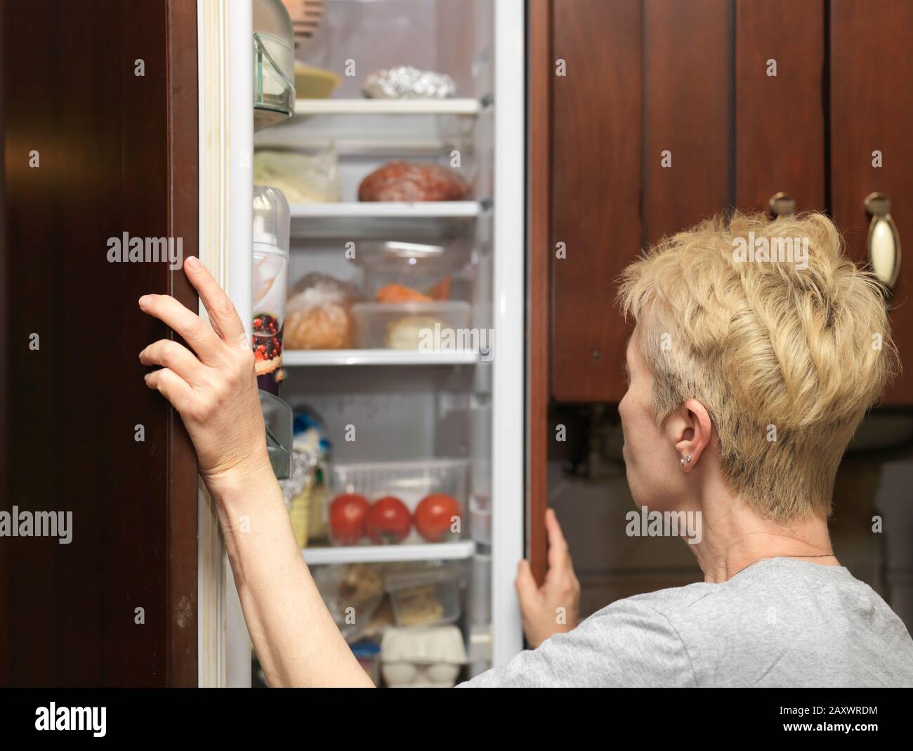 Woman opening fridge door hi-res stock photography and images - Alamy