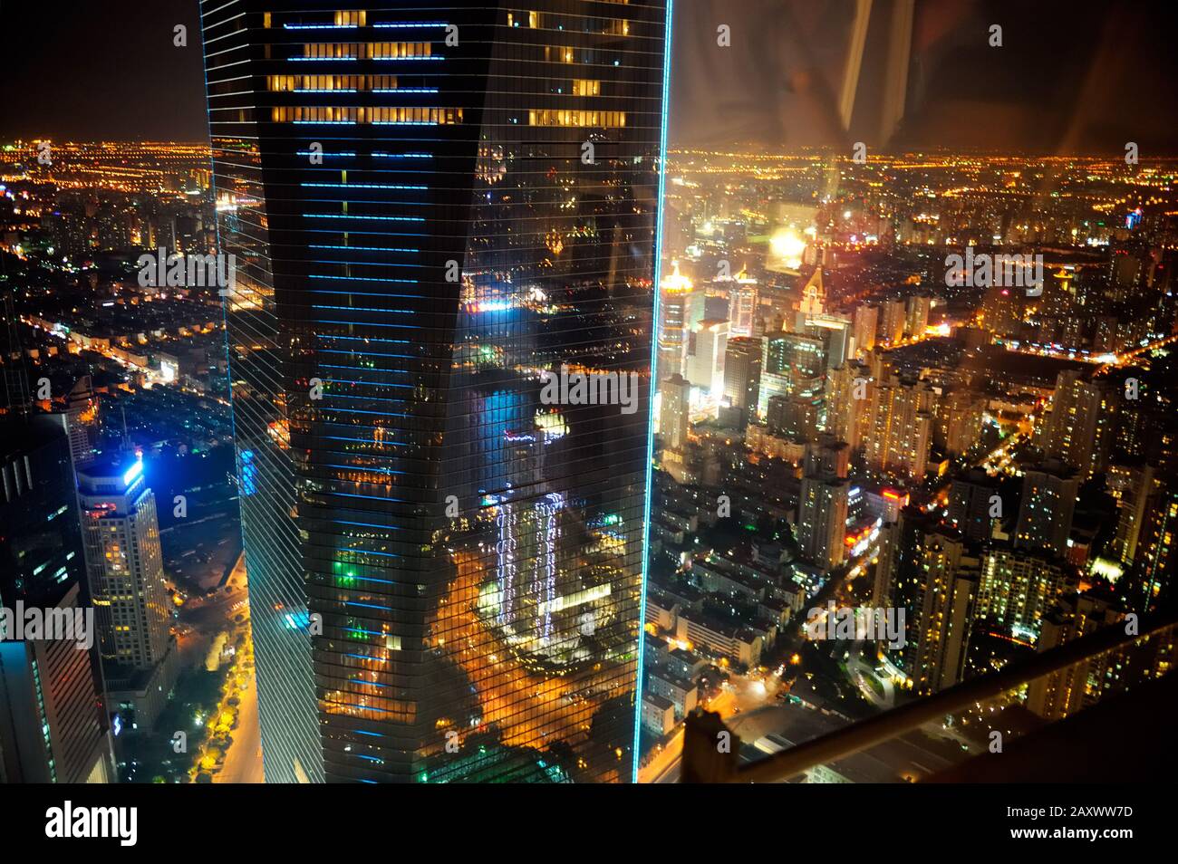 Aerial view of Shanghai by night and reflections of city light and ...
