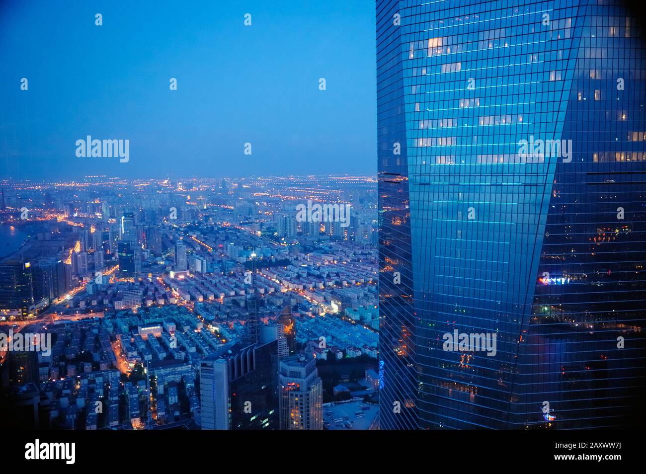 Aerial view of Shanghai by night and reflections of city light in glass ...
