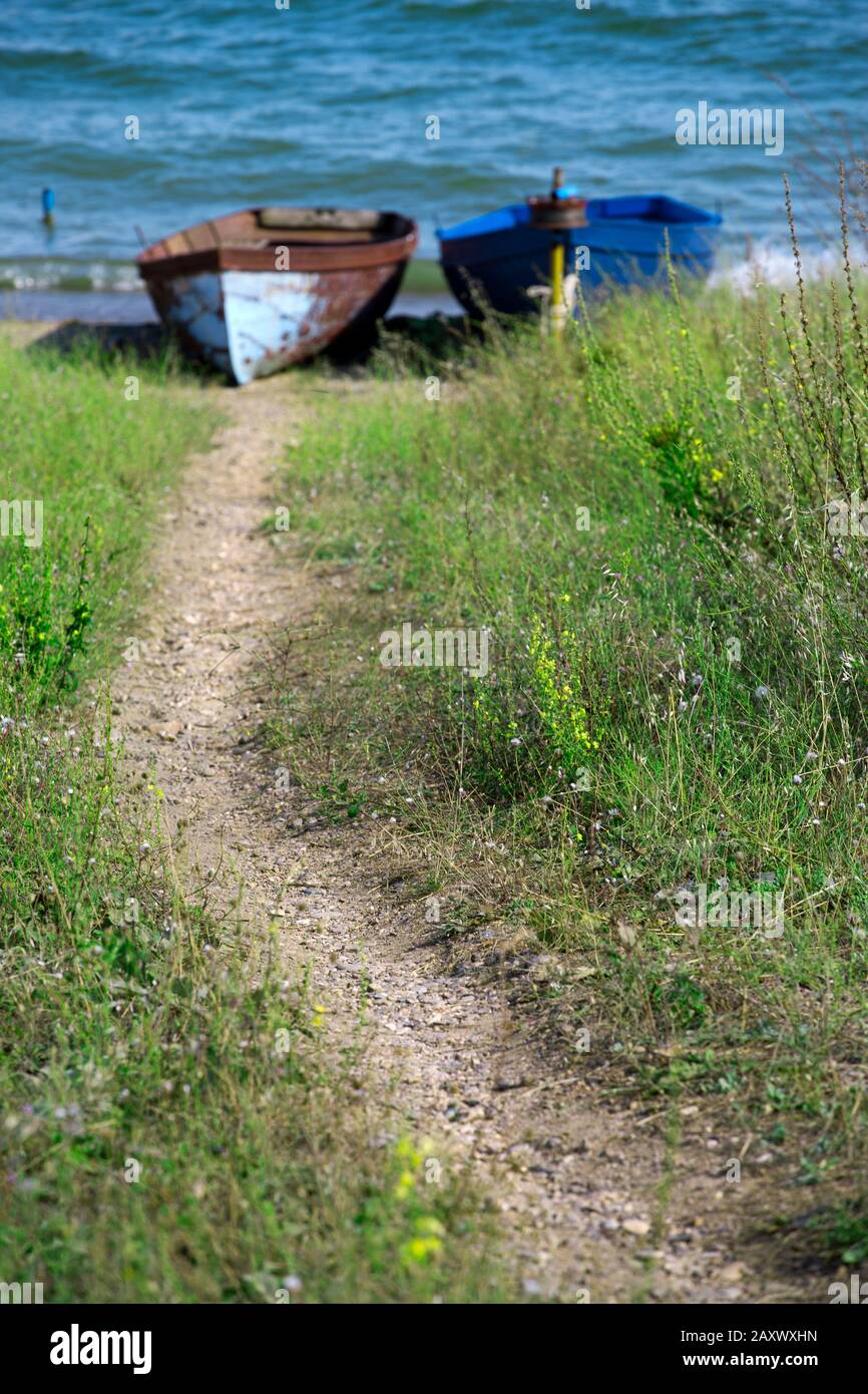 Path leading to two boats Stock Photo - Alamy