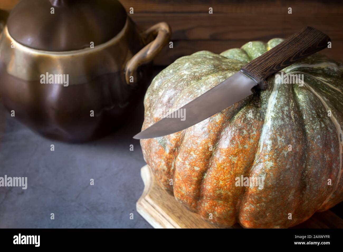 A large pumpkin next to a ceramic pot Stock Photo - Alamy