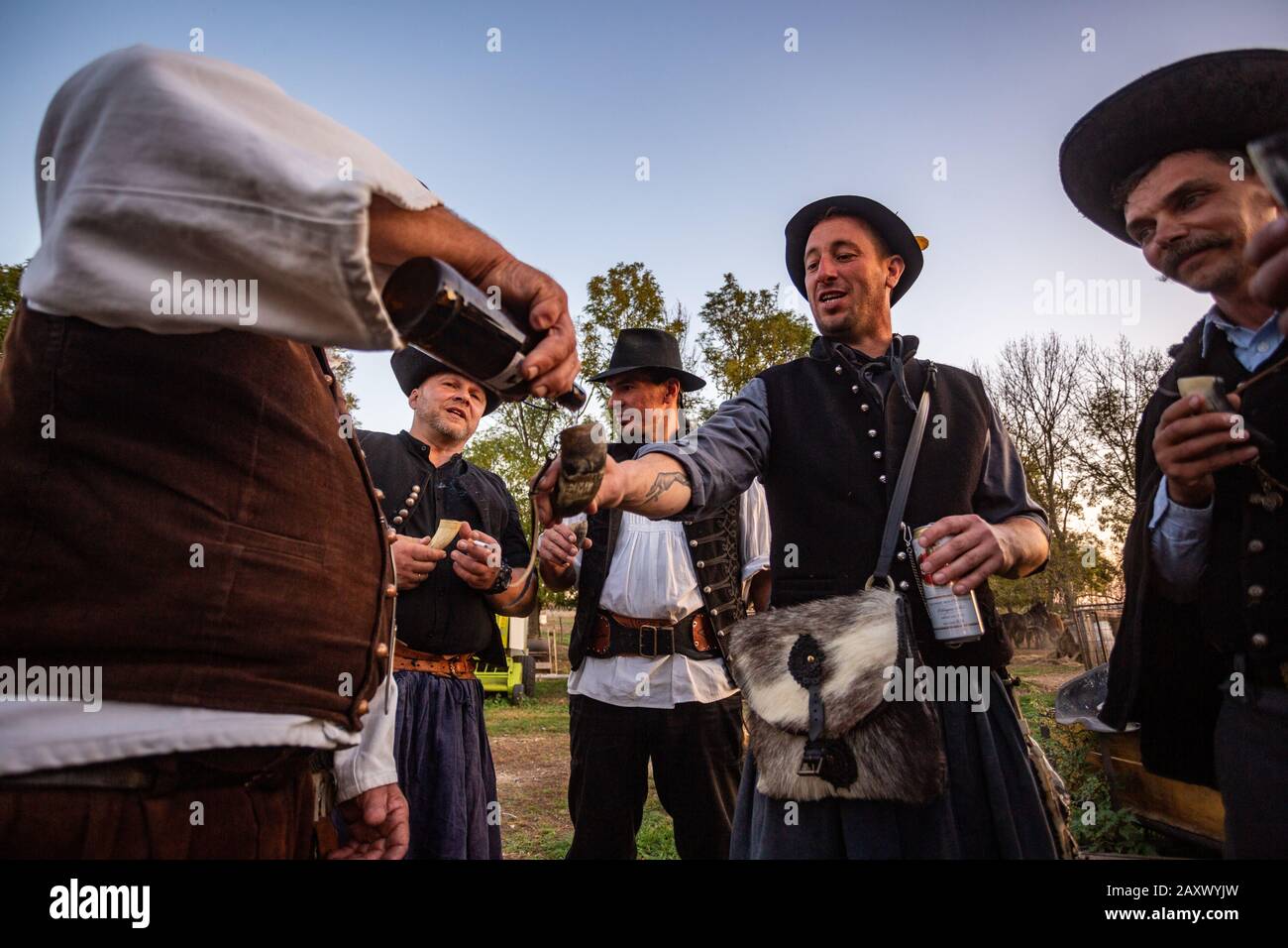 Shepherds are drinking Hungarian palinka as a greeting Stock Photo - Alamy