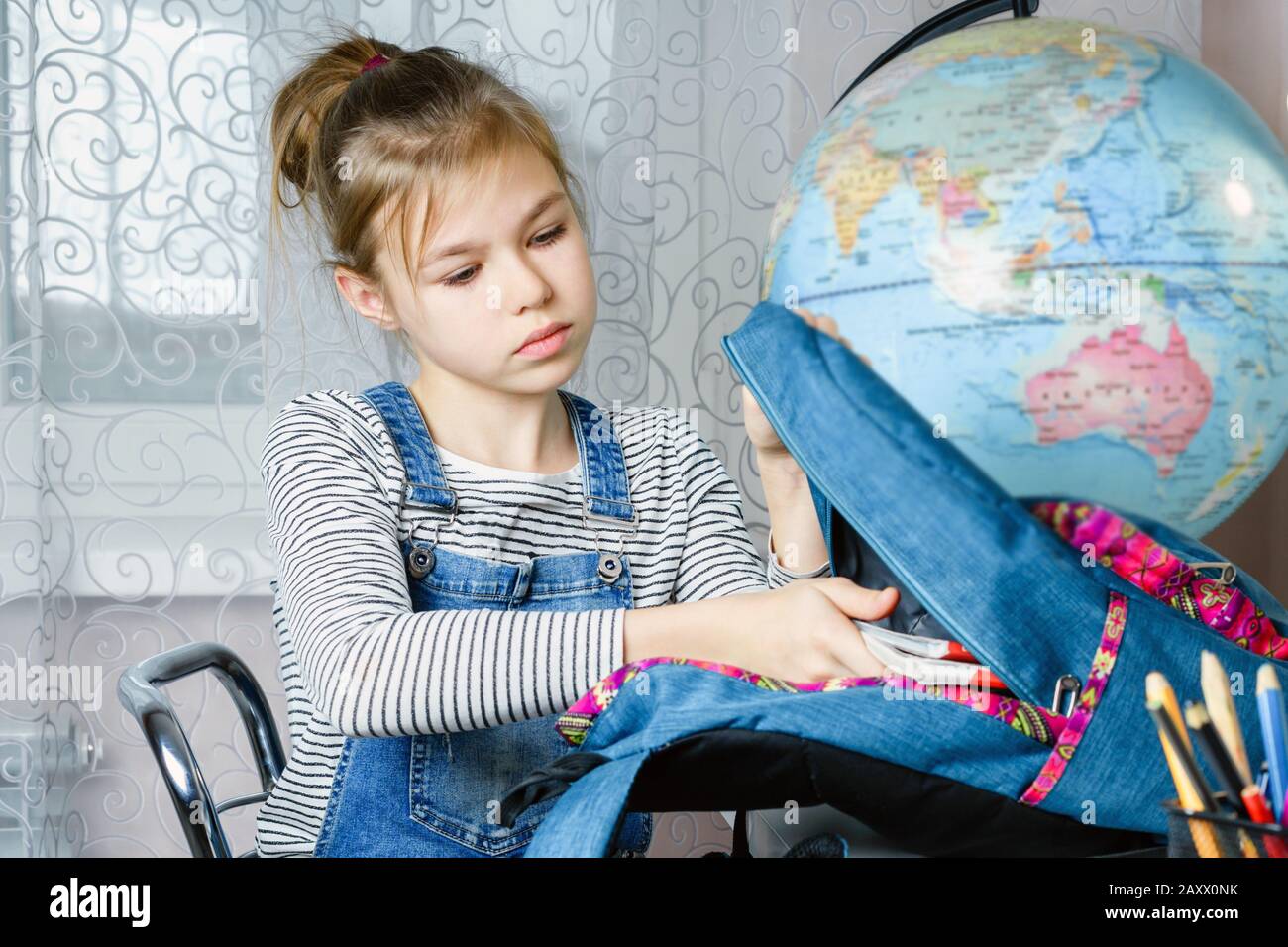 daughter packing stuff in backpack for school Stock Photo - Alamy