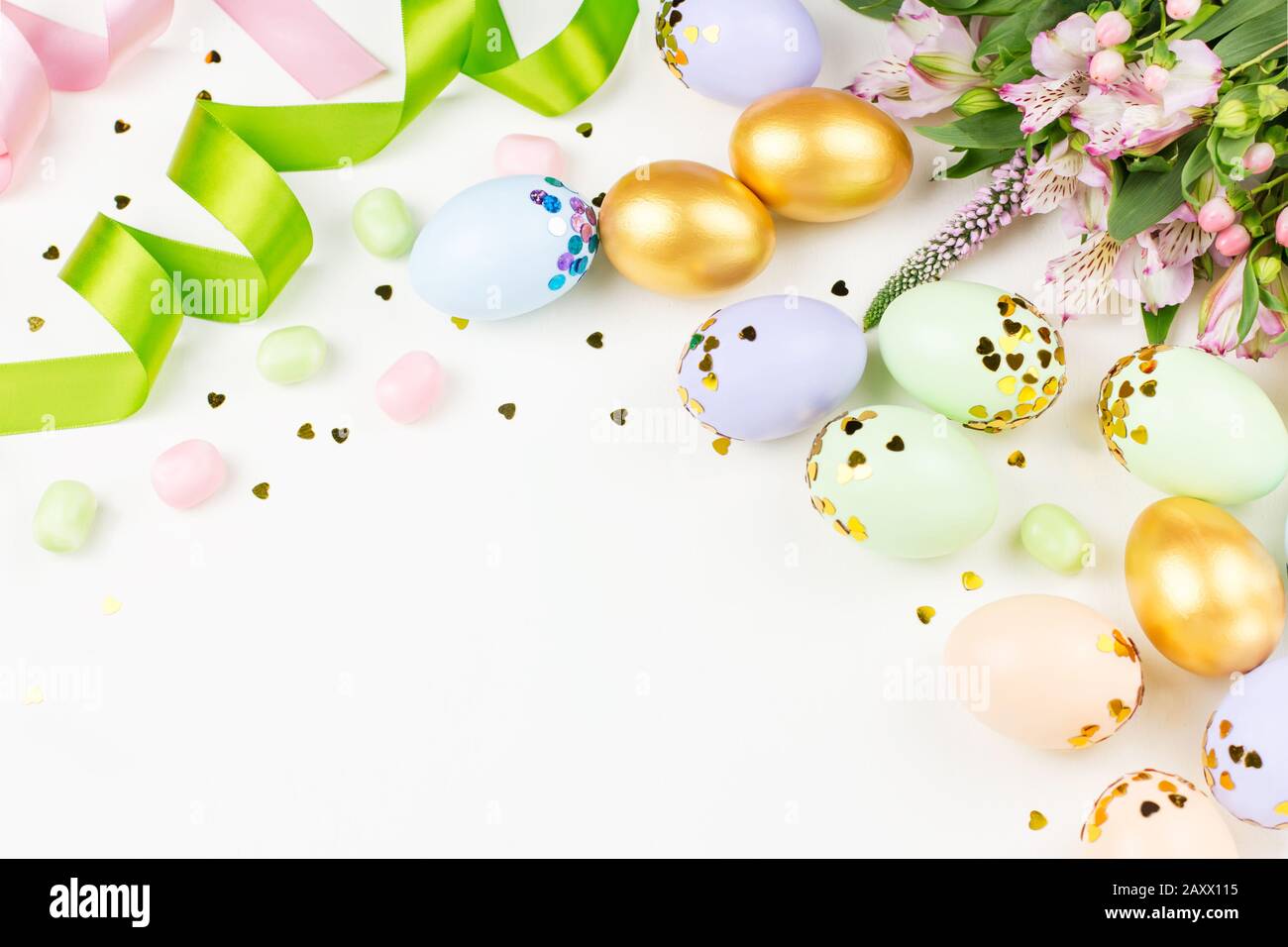 Festive Easter background with decorated eggs, flowers, candy and ...