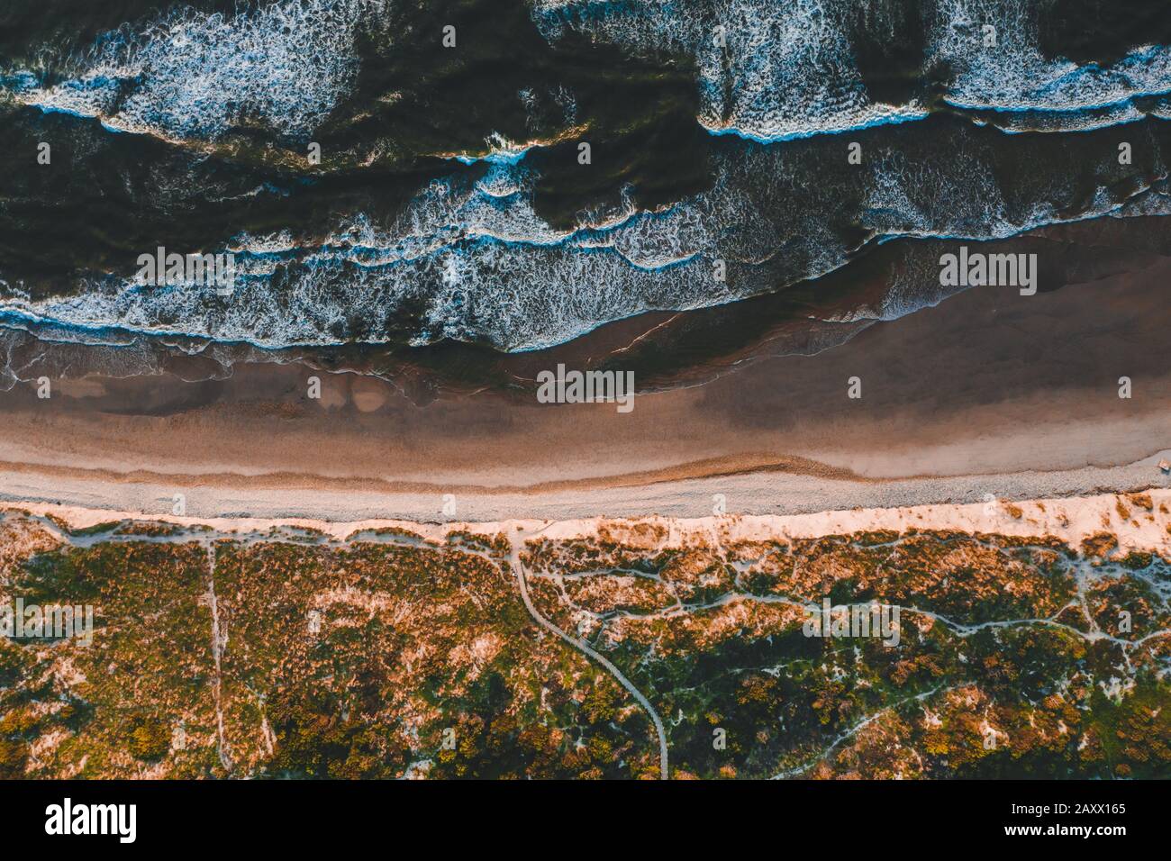 Aerial view of the beautiful coastline with ocean waves crashing into ...