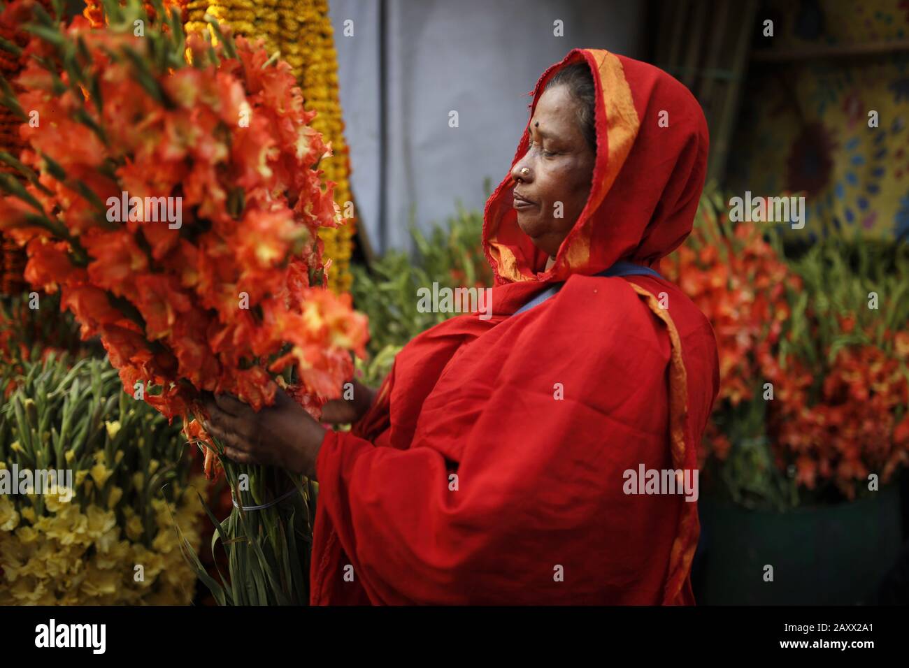 Dhaka, Bangladesh. 14th Feb, 2020. Golechha Begam (50), a flower vendor ...