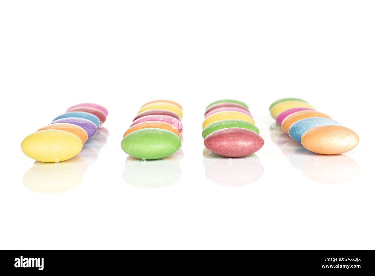 Lot of whole sweet colourful candy four lines isolated on white ...