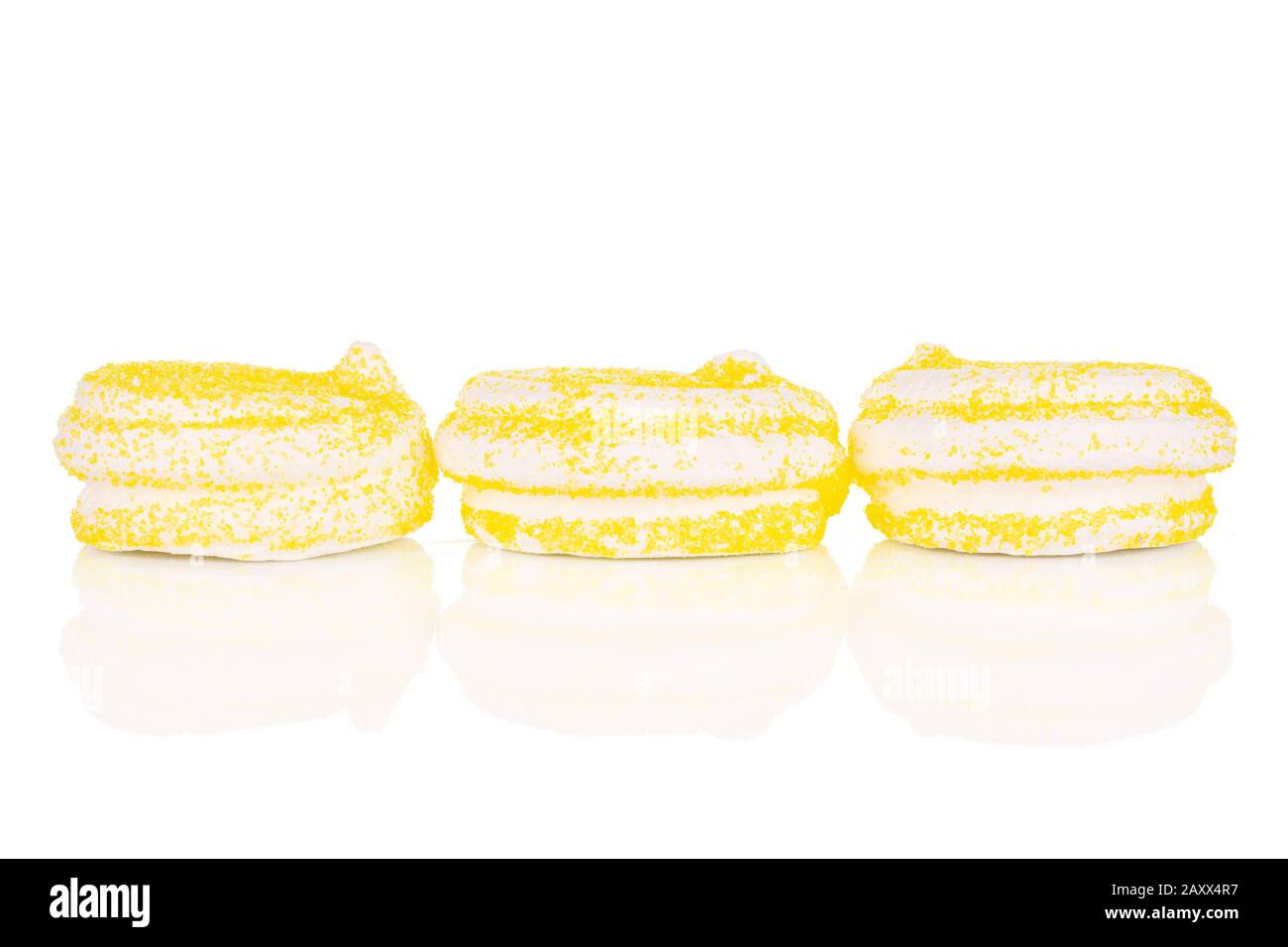 Group of three whole yellow sweet meringue in row isolated on white ...