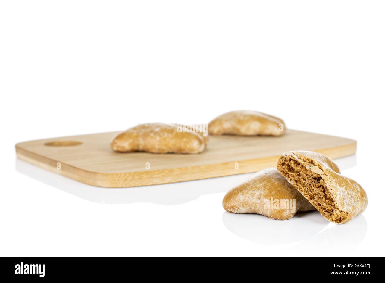 Group of three whole one half of sweet brown gingerbread on bamboo ...