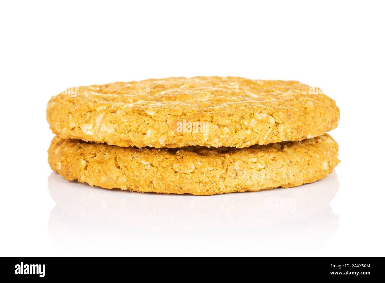 Group of two whole sweet golden oat cookie isolated on white background ...