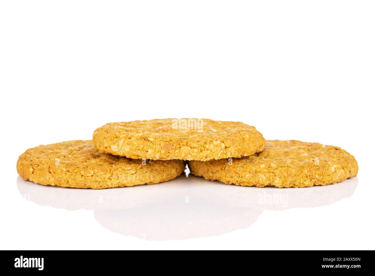 Group of three whole sweet golden oat cookie isolated on white ...