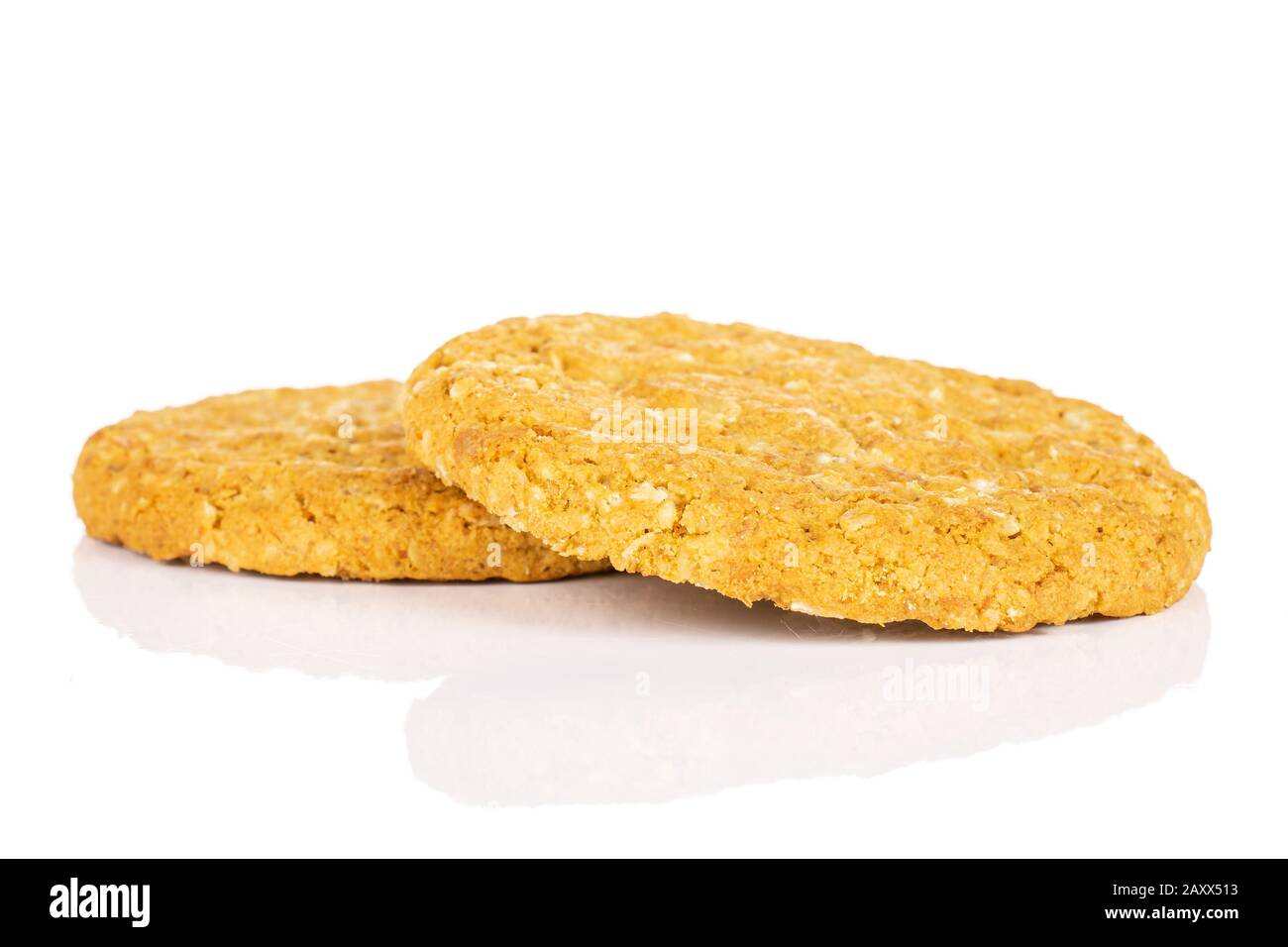 Group of two whole sweet golden oat cookie isolated on white background ...