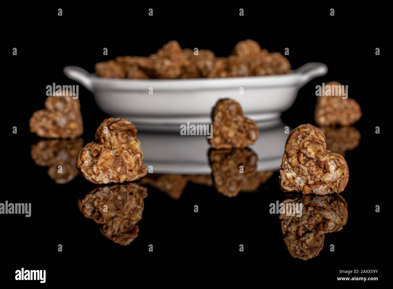 Lot of whole healthy brown cereal heart with cocoa in white oval ...