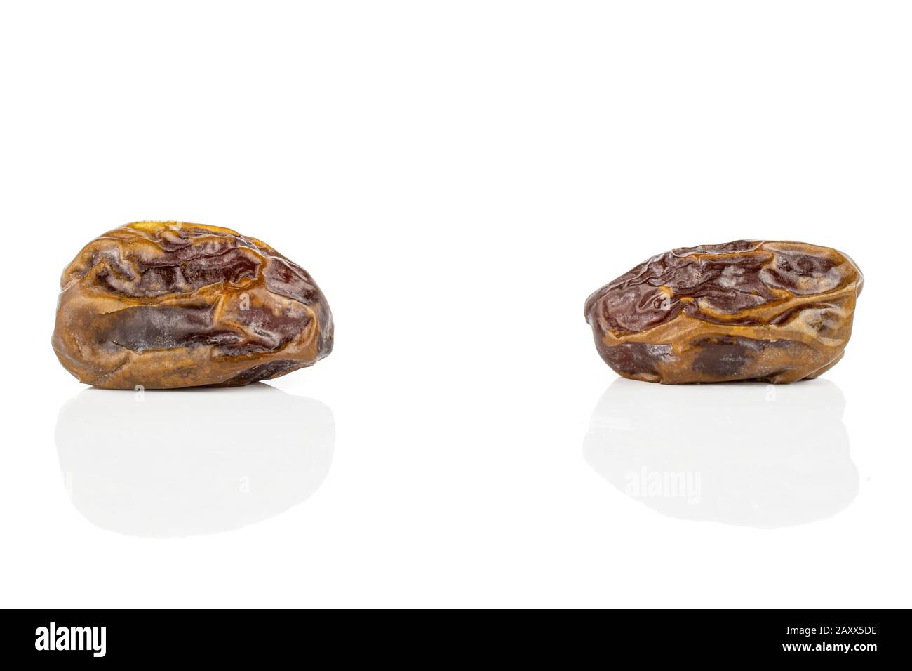 Group of two whole dry brown date fruit isolated on white background ...