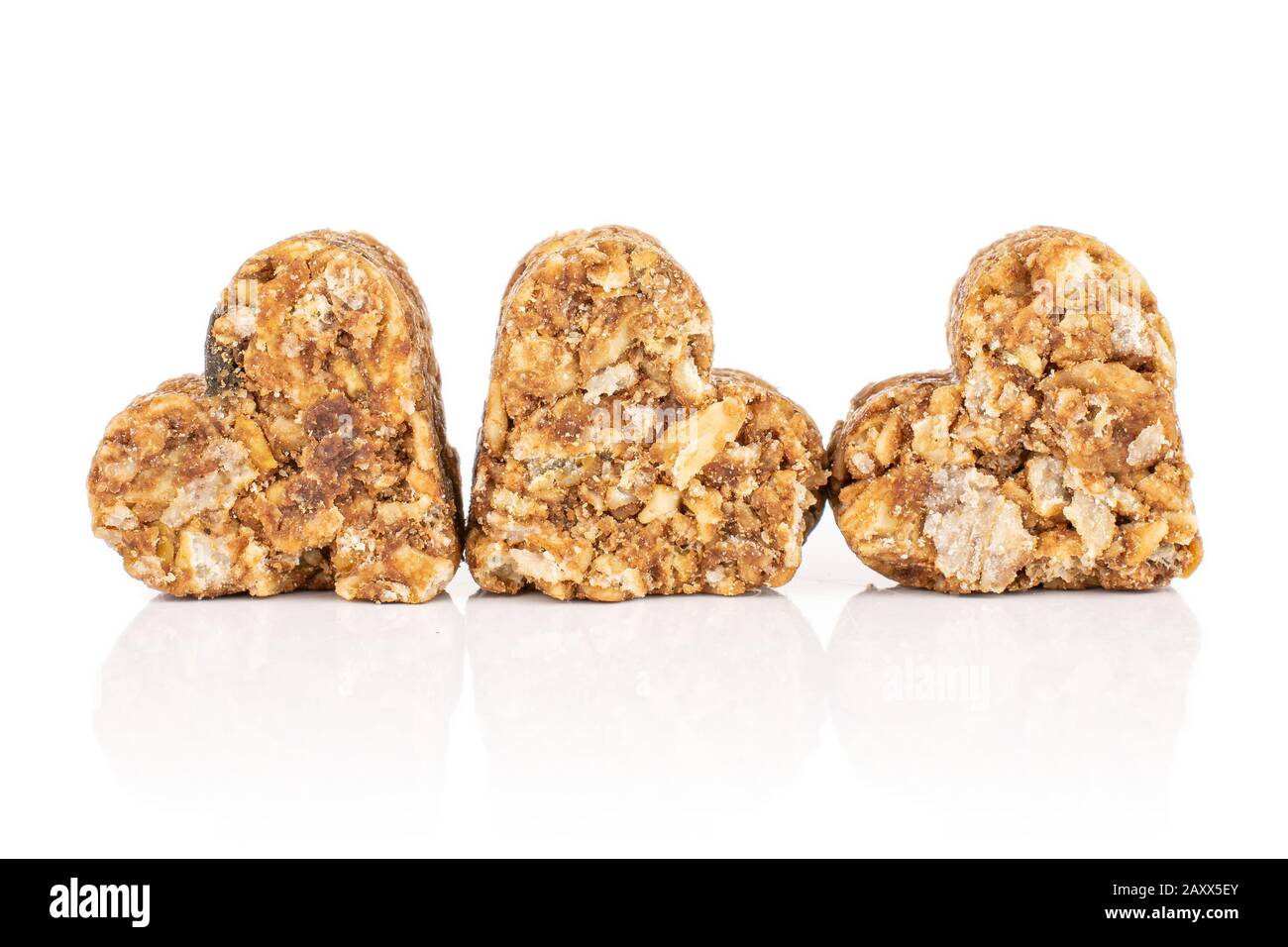 Group of three whole healthy brown cereal heart with cocoa isolated on ...