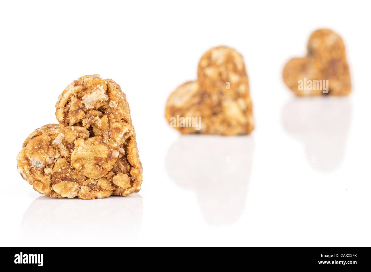 Group of three whole healthy brown cereal heart with cocoa placed ...