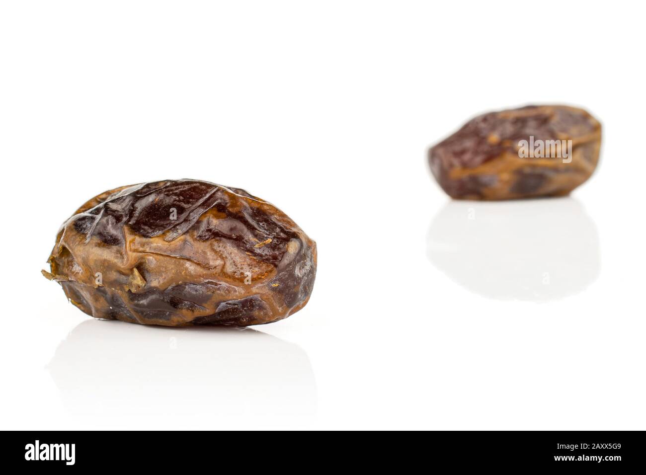 Group of two whole dry brown date fruit isolated on white background ...