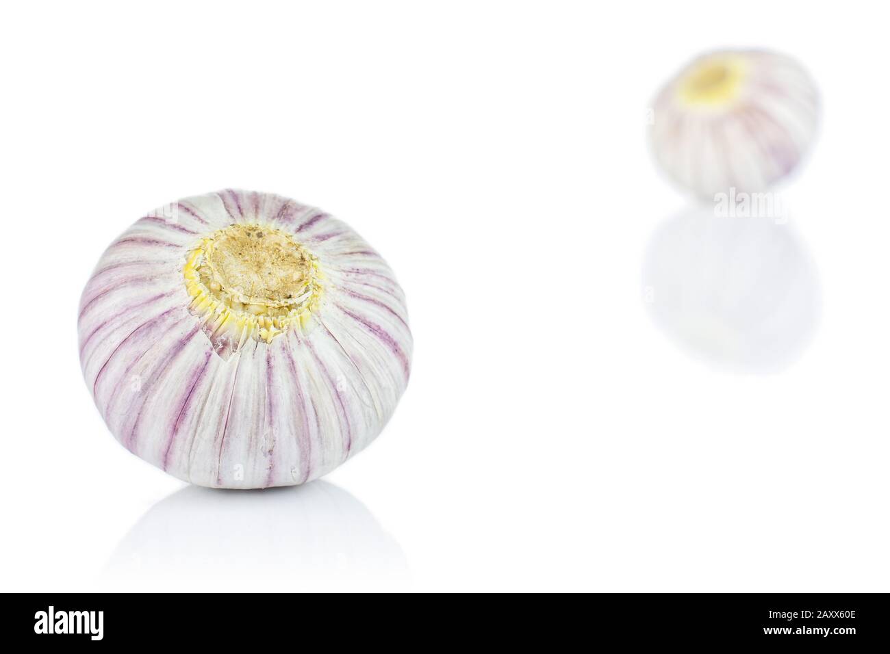 Group of two whole fresh purple single clove garlic isolated on white ...
